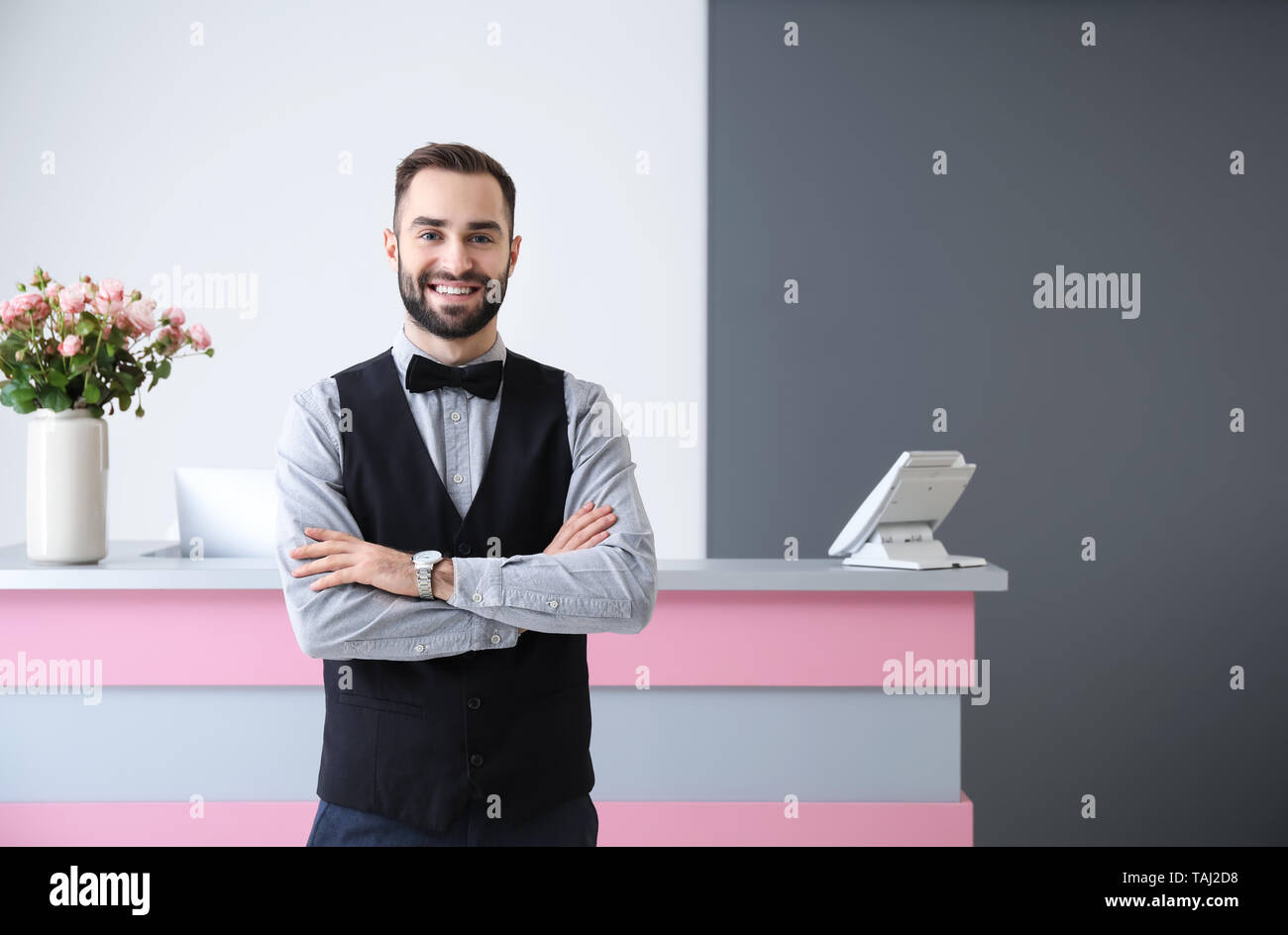 Portrait of male receptionist in hotel Stock Photo - Alamy