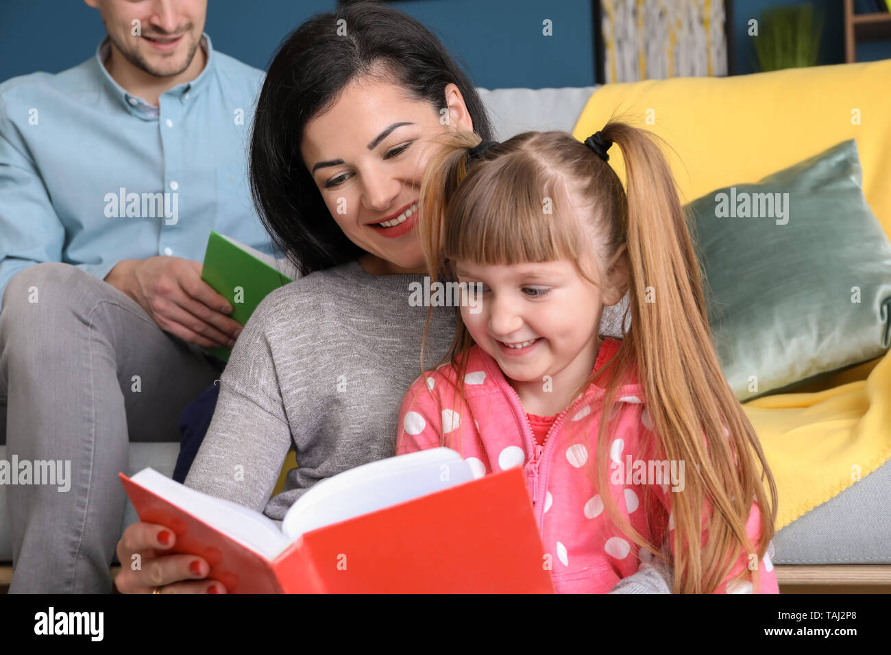Happy family reading books at home Stock Photo - Alamy