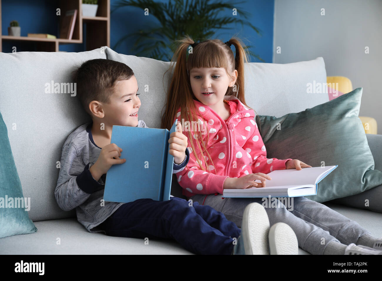 Cute little children reading books at home Stock Photo - Alamy