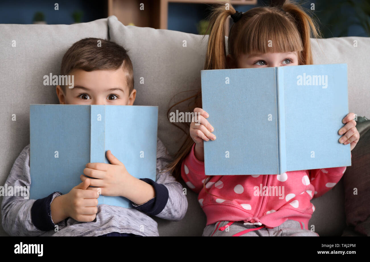 Cute little children reading books at home Stock Photo - Alamy