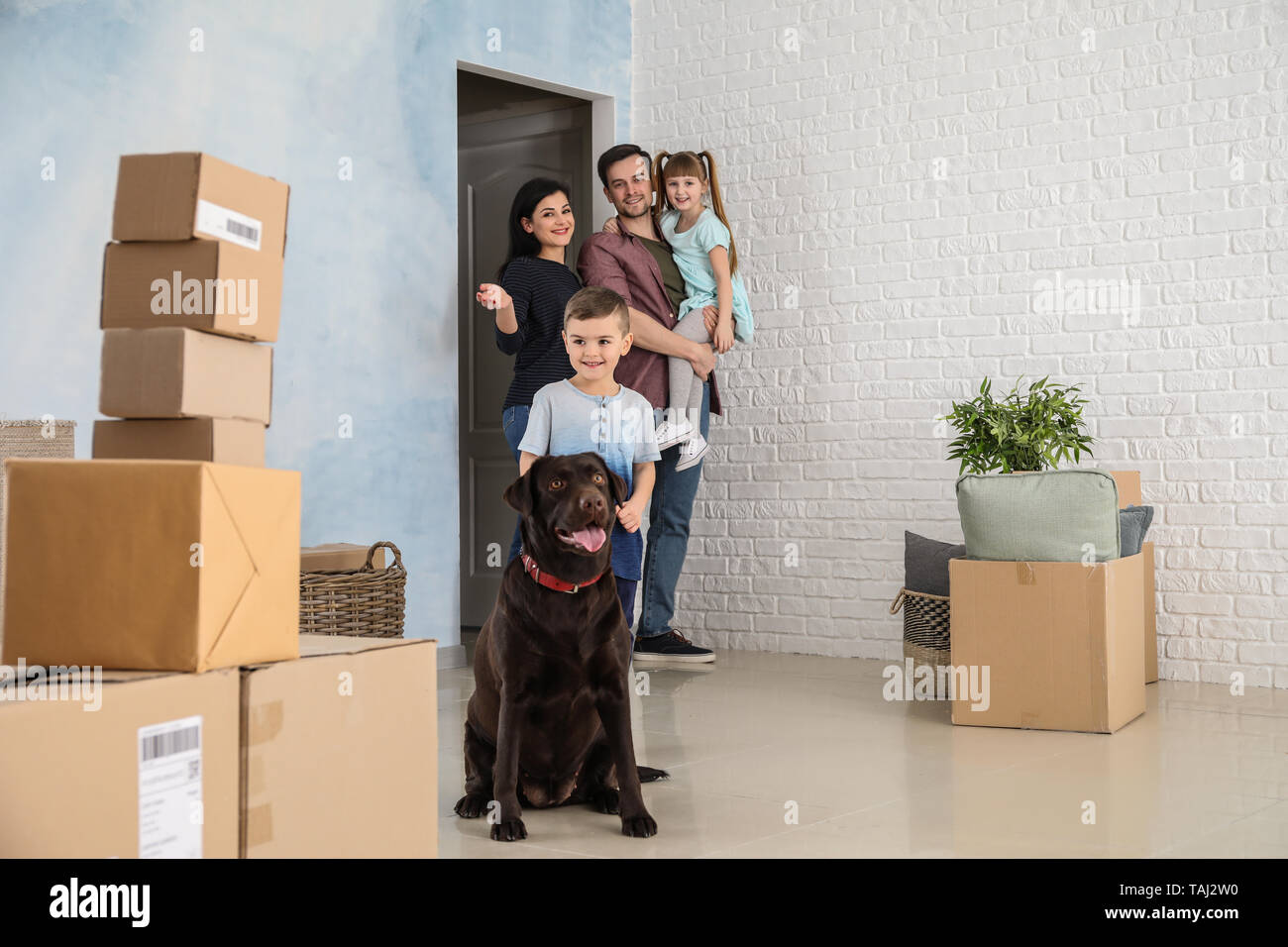 Family unpacking things after moving into new house Stock Photo - Alamy