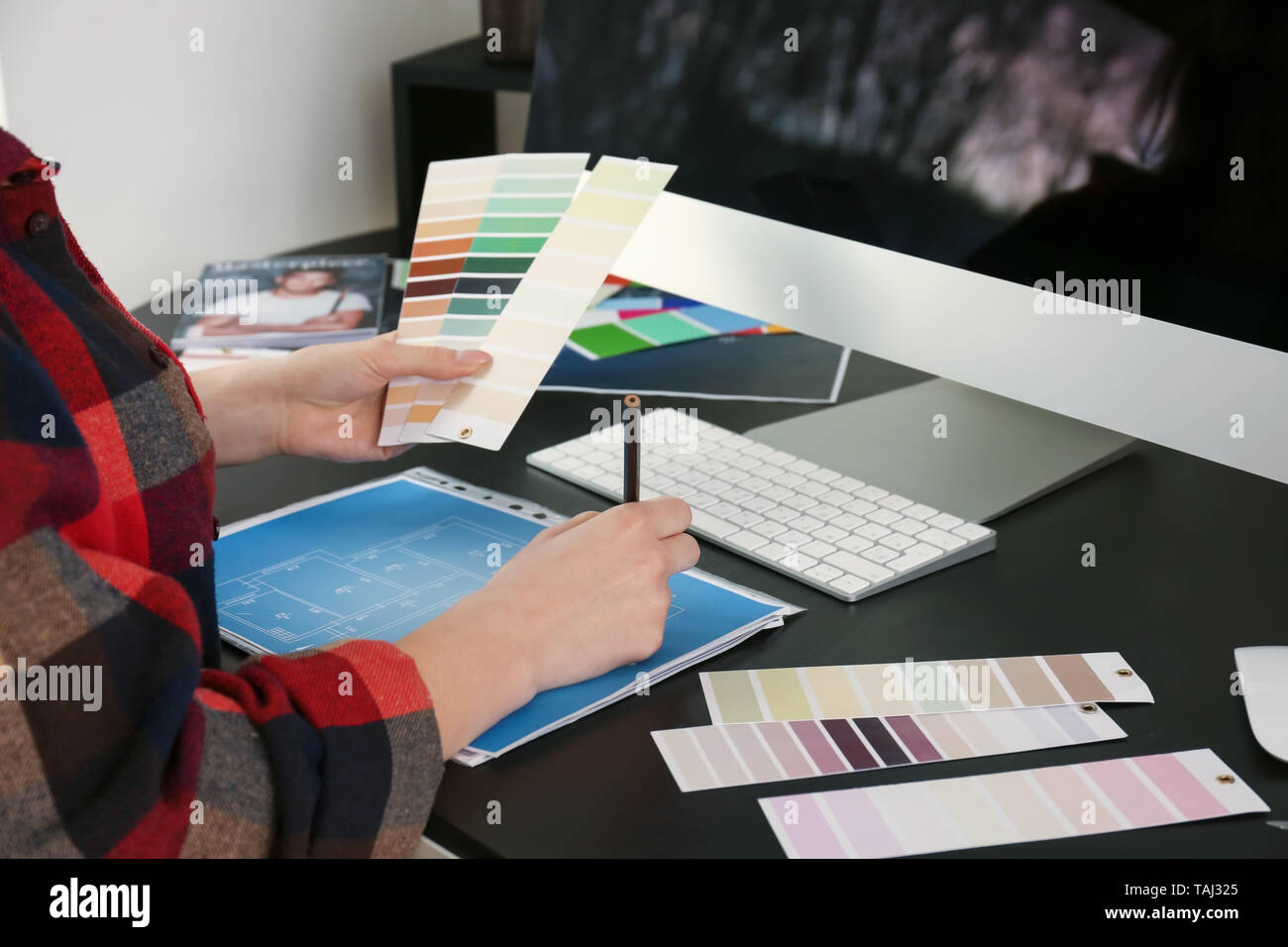 Female interior designer working in office Stock Photo - Alamy