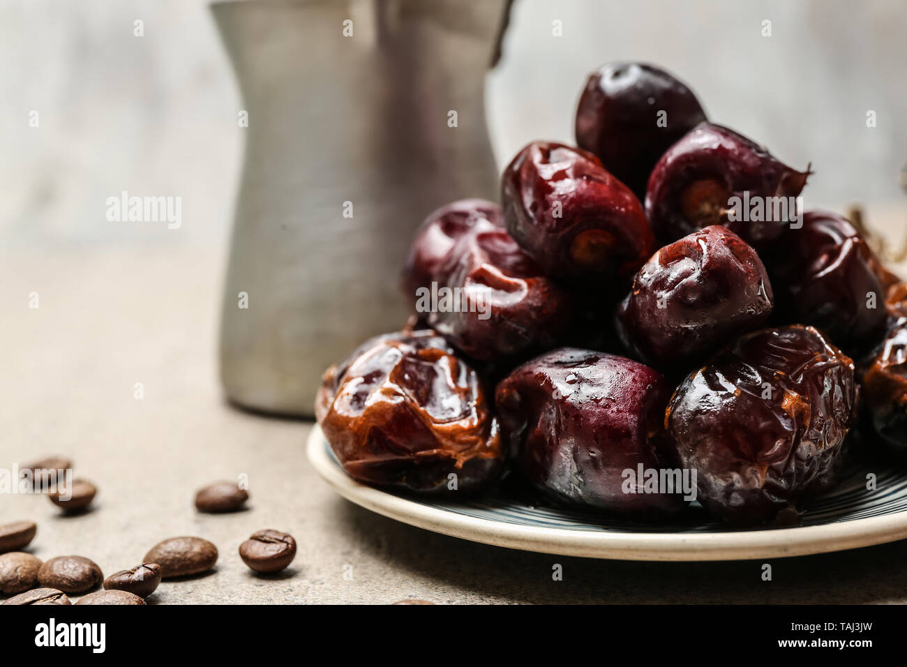 Plate with tasty dates on table, closeup Stock Photo - Alamy
