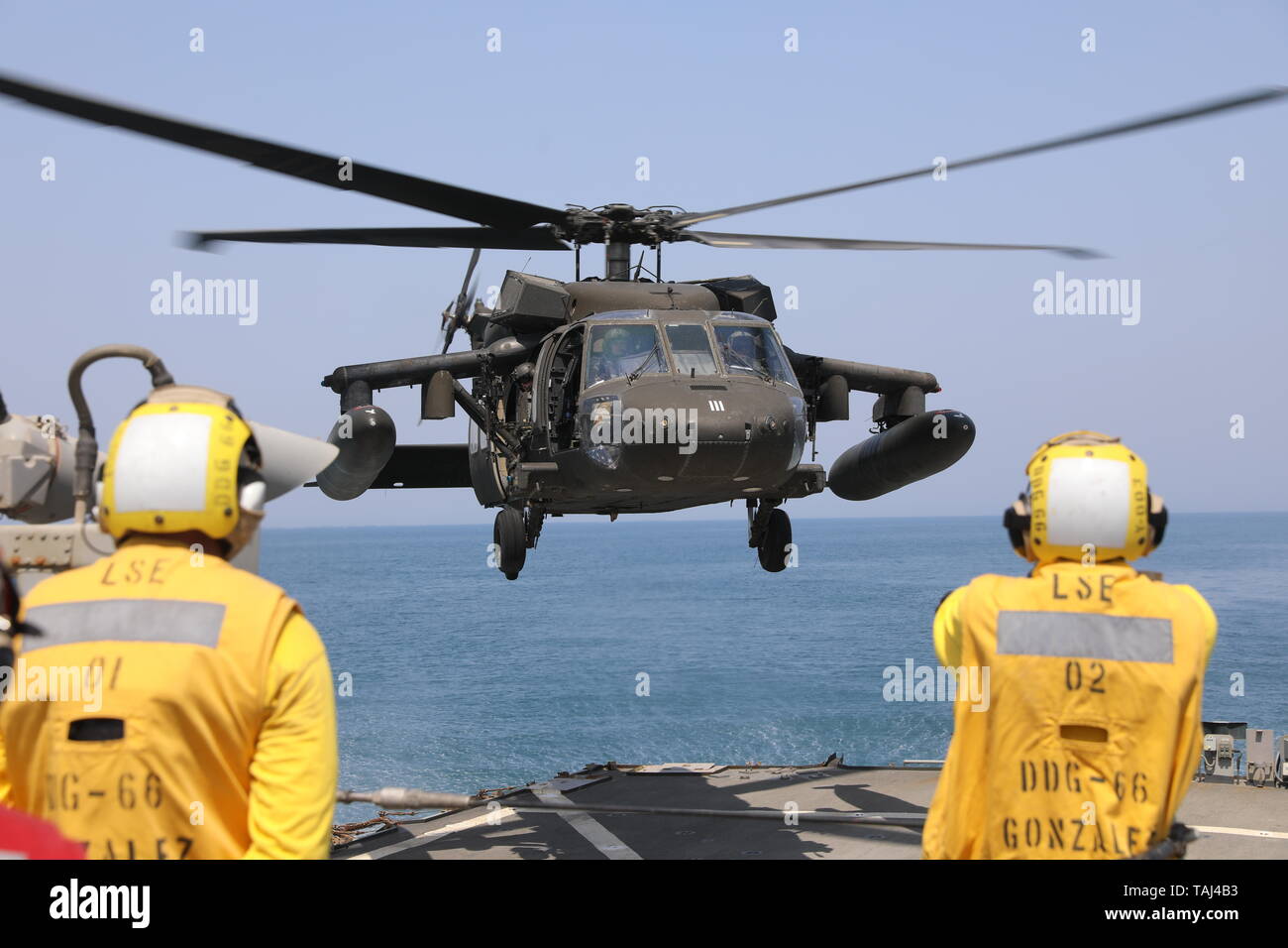 190522-A-BM388-04 A U.S. Navy Sailor guides a U.S. Army UH-60 Black ...
