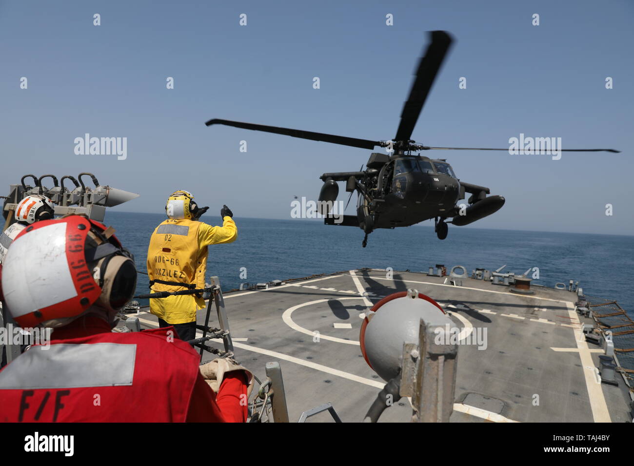190522-A-BM388-05 A U.S. Navy Sailor guides a U.S. Army UH-60 Black ...