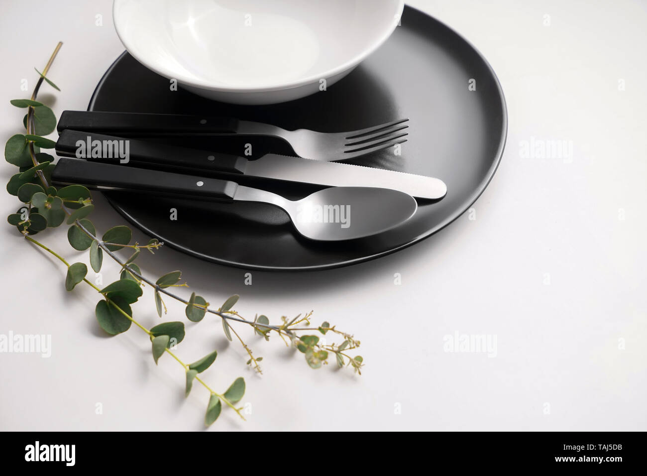 Simple table setting on white background Stock Photo - Alamy