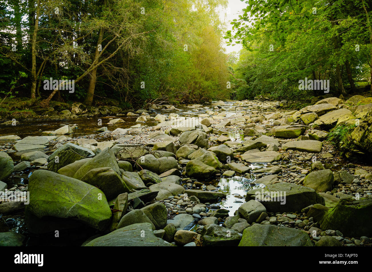 A rocky riverbed is revealed during low water levels in a Scottish ...