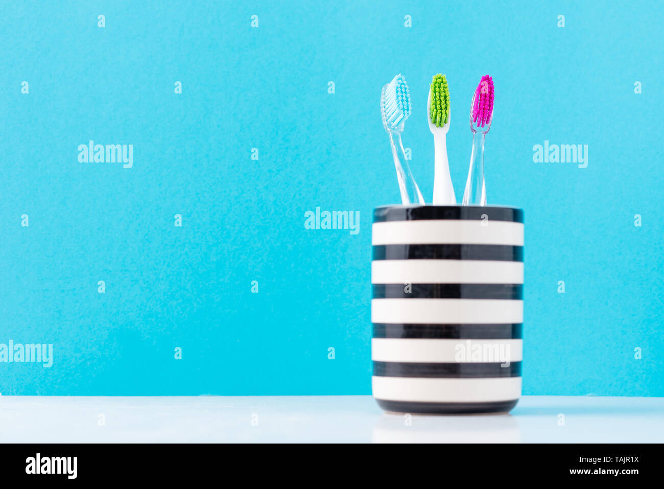 Toothbrush and toothpaste in cup hi-res stock photography and images ...