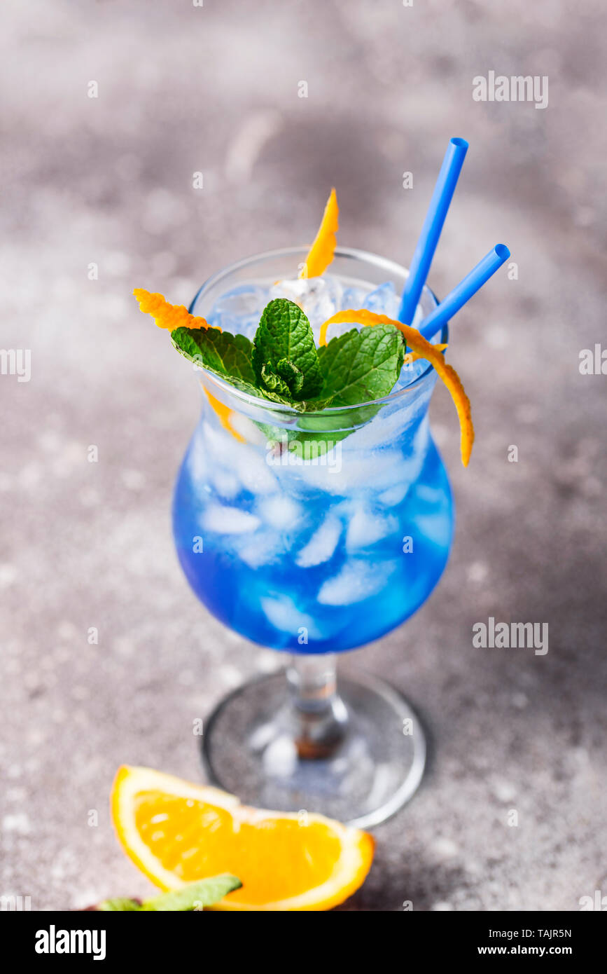 Blue cocktail drink with ice and orange Stock Photo - Alamy