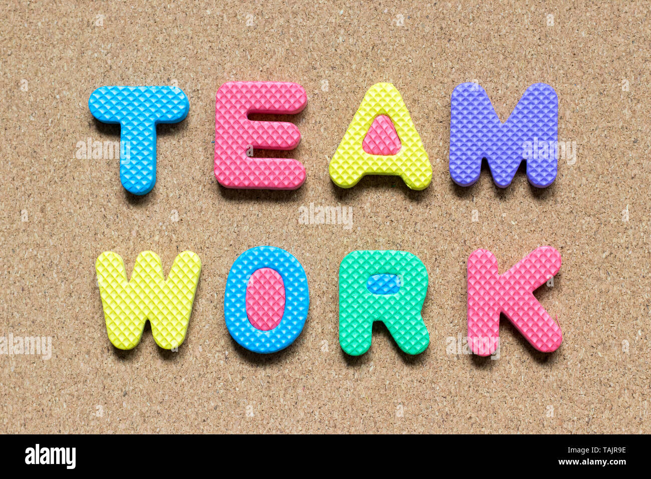 Color foam alphabet in word teamwork on cork board background Stock ...