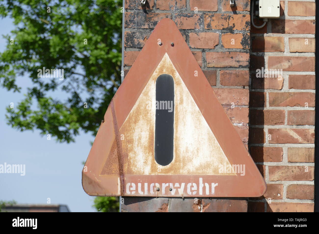 Old rusted road sign. Hazard spot, fire department Stock Photo - Alamy