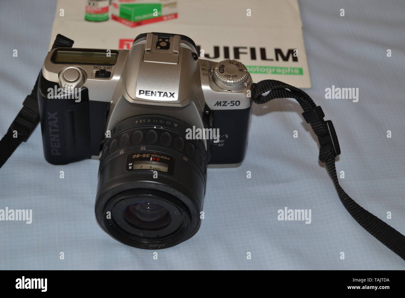 Pentax 35mm film camera and Fuji photo packaging envelope reflecting ...