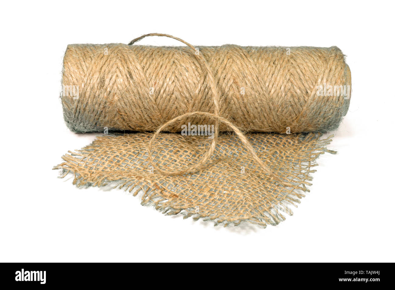 Jute fabric and spool of burlap threads isolated on white Stock Photo ...