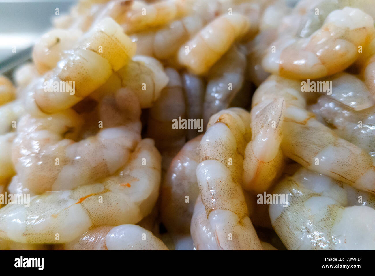 raw prawns grouped on a tray Stock Photo - Alamy