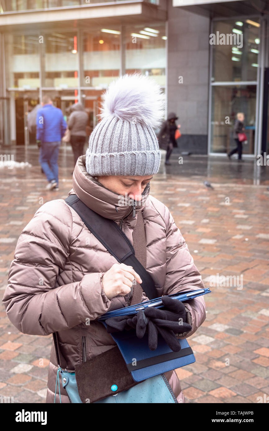 Woman browsing on tablet walking hi-res stock photography and images ...