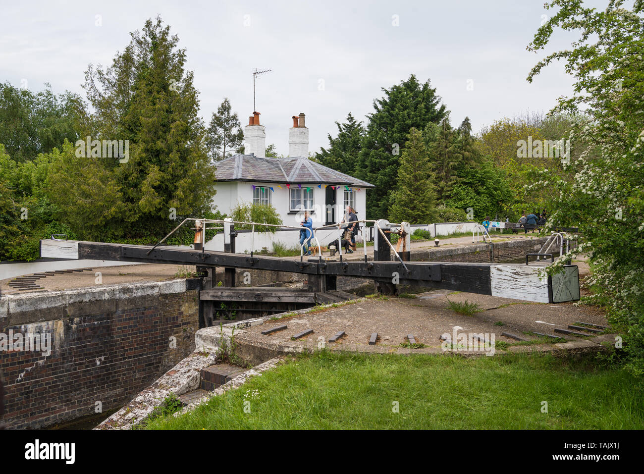 People walking the tow path pass by the lock keepers cottage at Lock ...