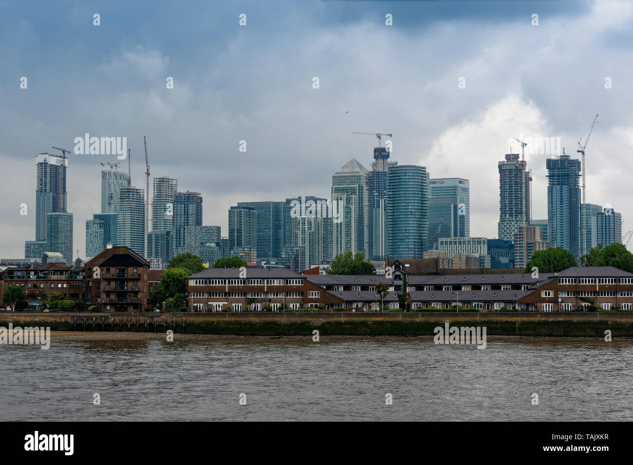 LONDON ISLE OF DOGS SKYSCRAPERS OF CANARY WHARF LOOM OVER THE RIVER ...
