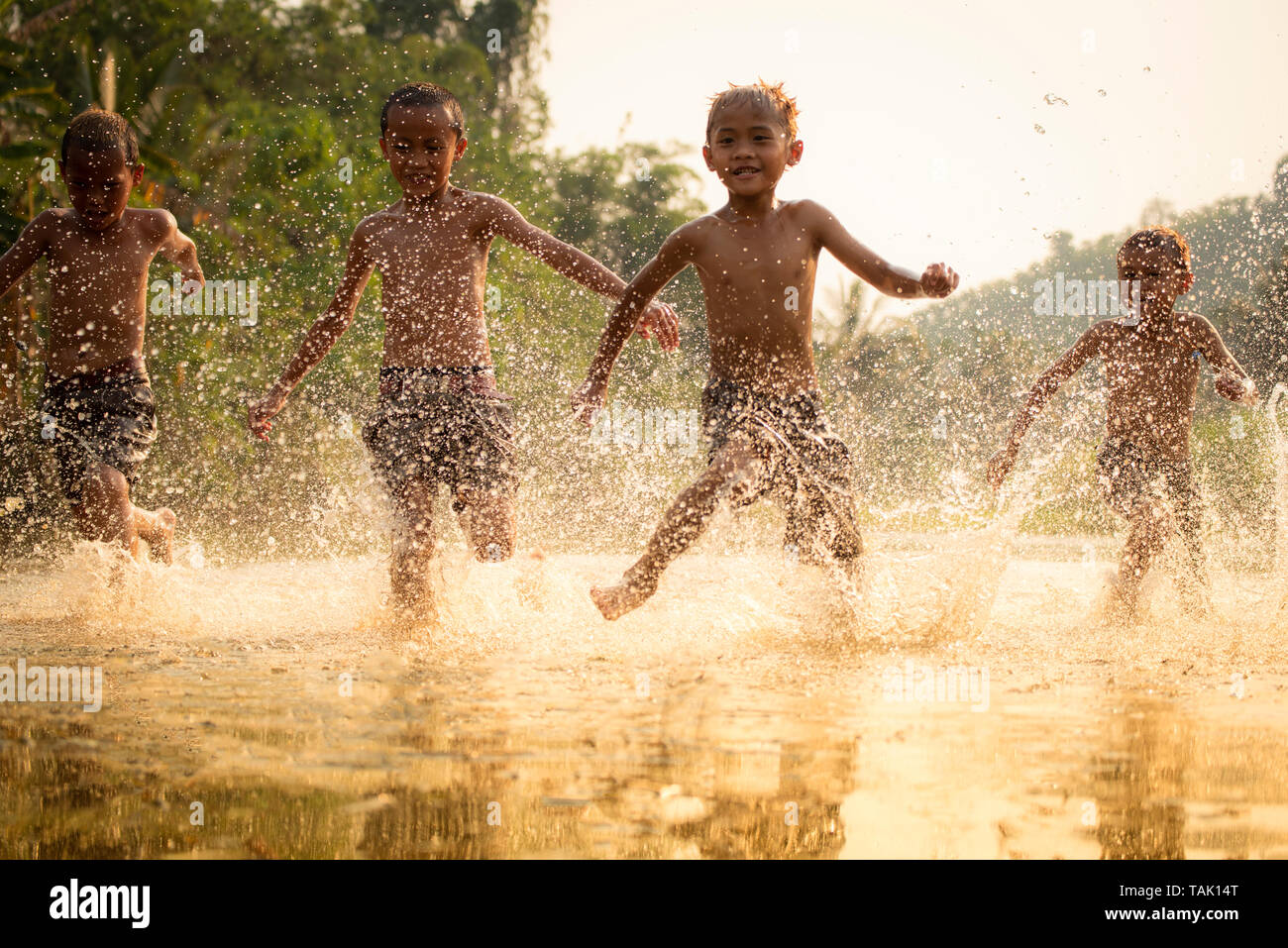 Asia children on river / The boy friend happy funny playing running in ...