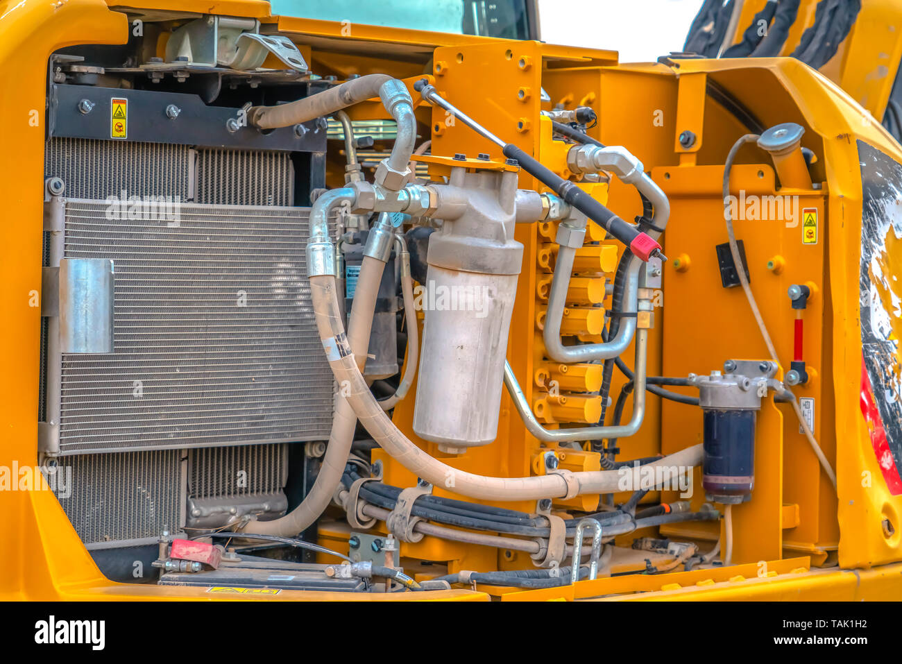Close up of the engine of a yellow heavy duty construction machinery ...