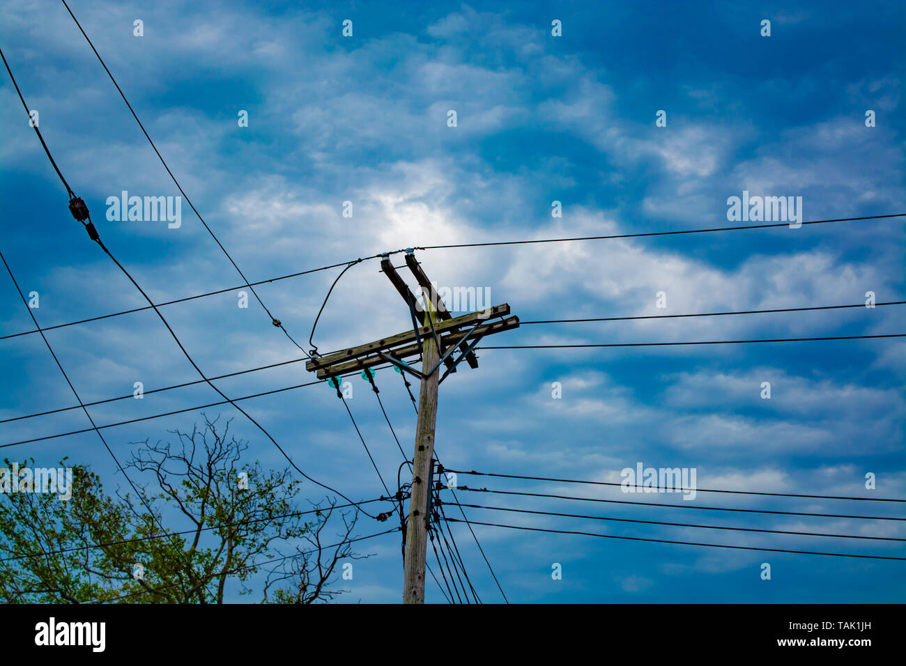 Electrical lines and cloudy sky Stock Photo - Alamy