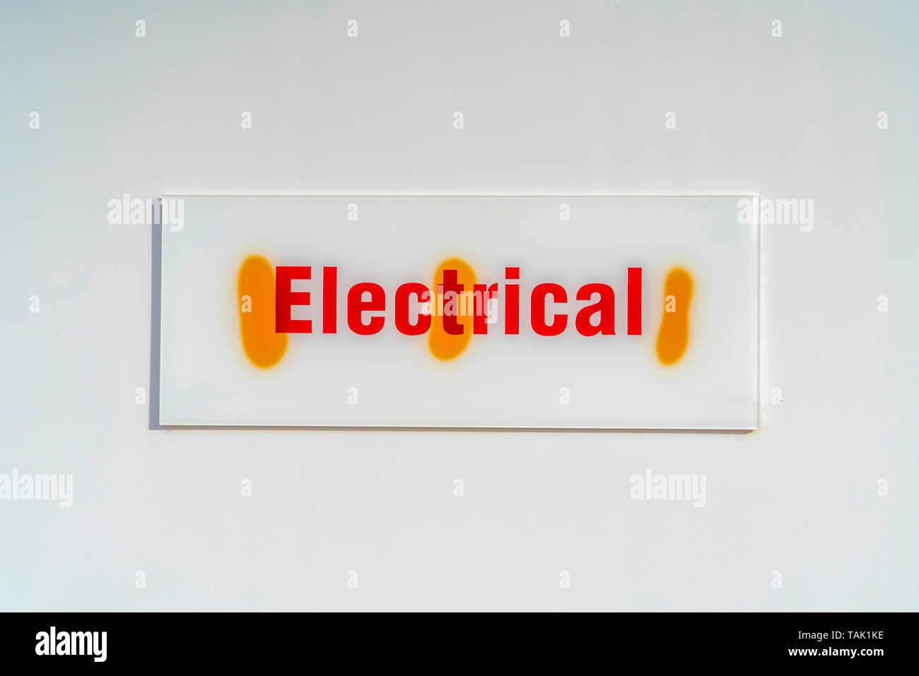 Close up of an electrical sign board against a white wall. The ...