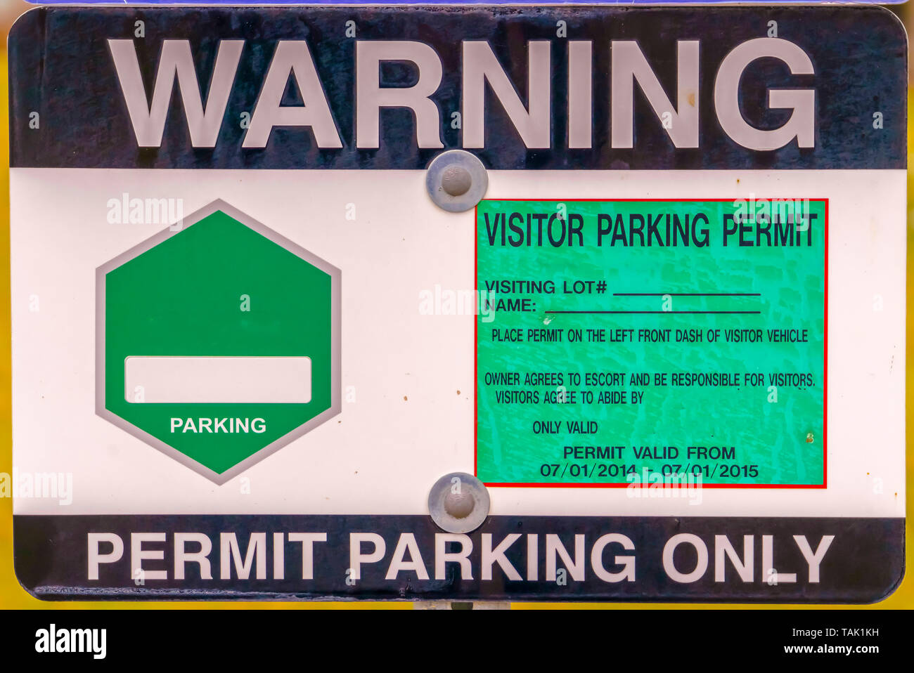 Close up view of a Warning Permit Parking Only sign board. A parking ...