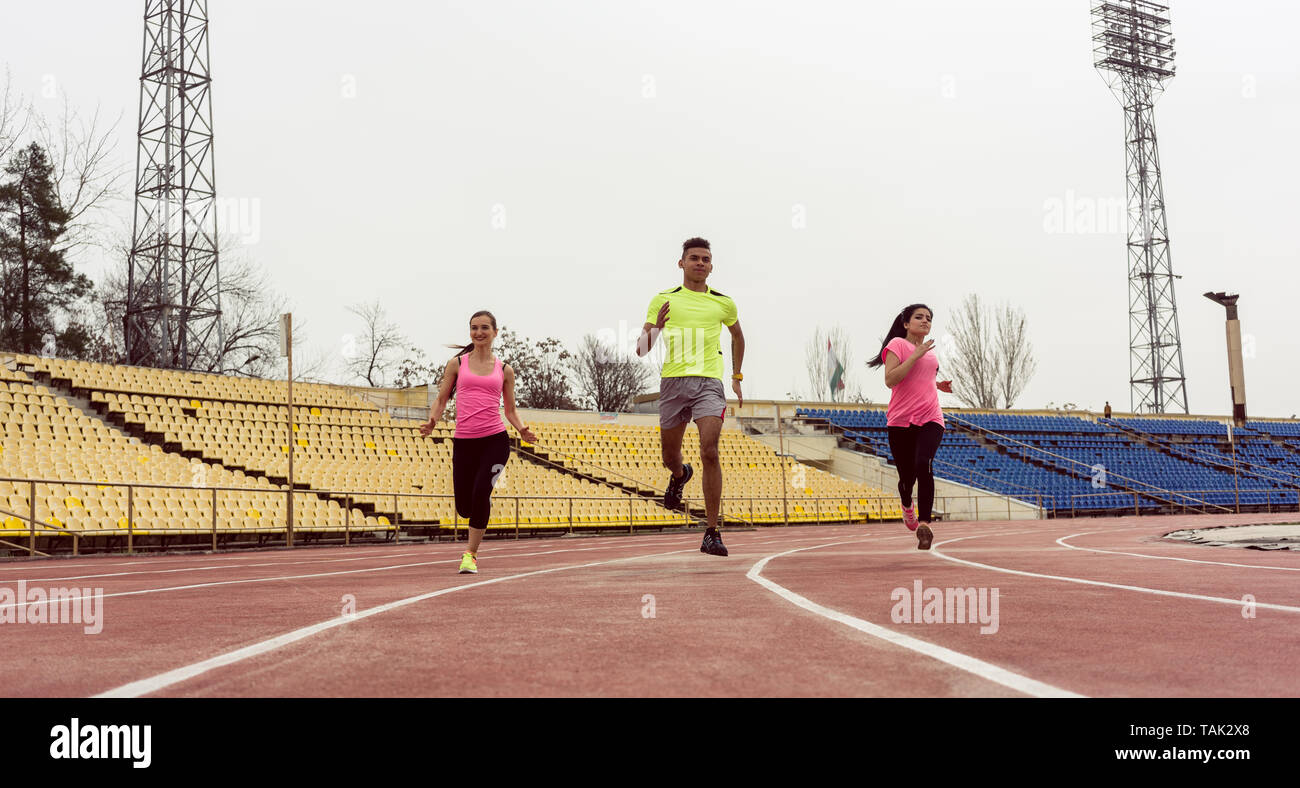 Three friend running in speed on playground Stock Photo - Alamy