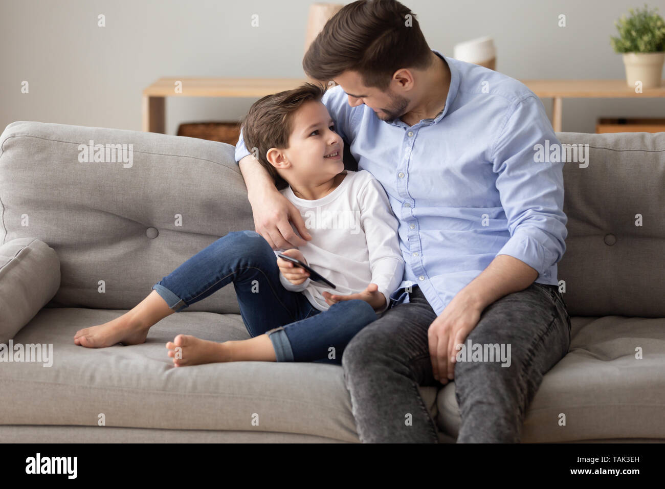 Happy dad and preschooler son relax on couch together Stock Photo - Alamy