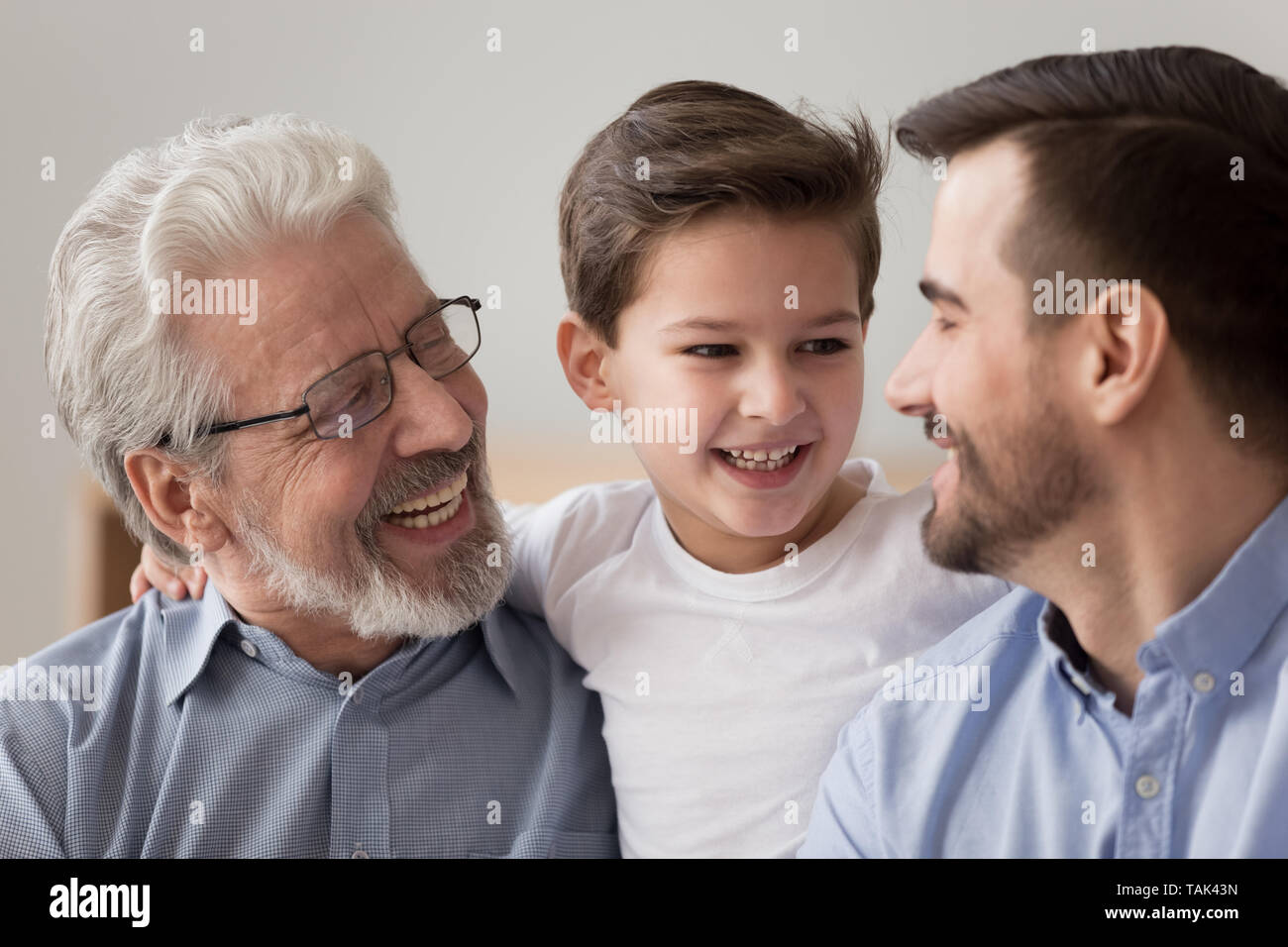 Close up of happy three generations of men have fun Stock Photo - Alamy