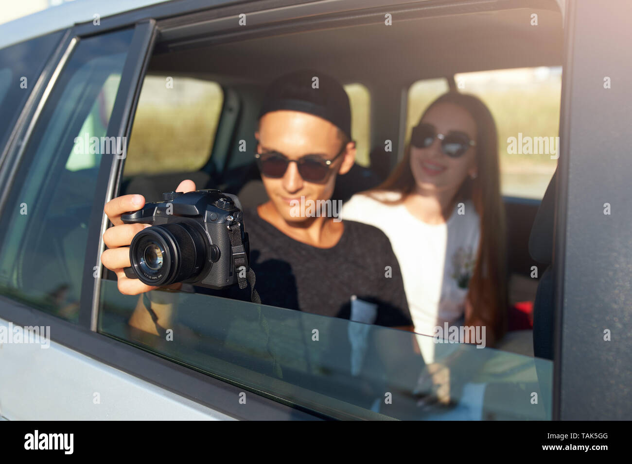 Blogger in glasses filming his travel vlog on professional camera on ...