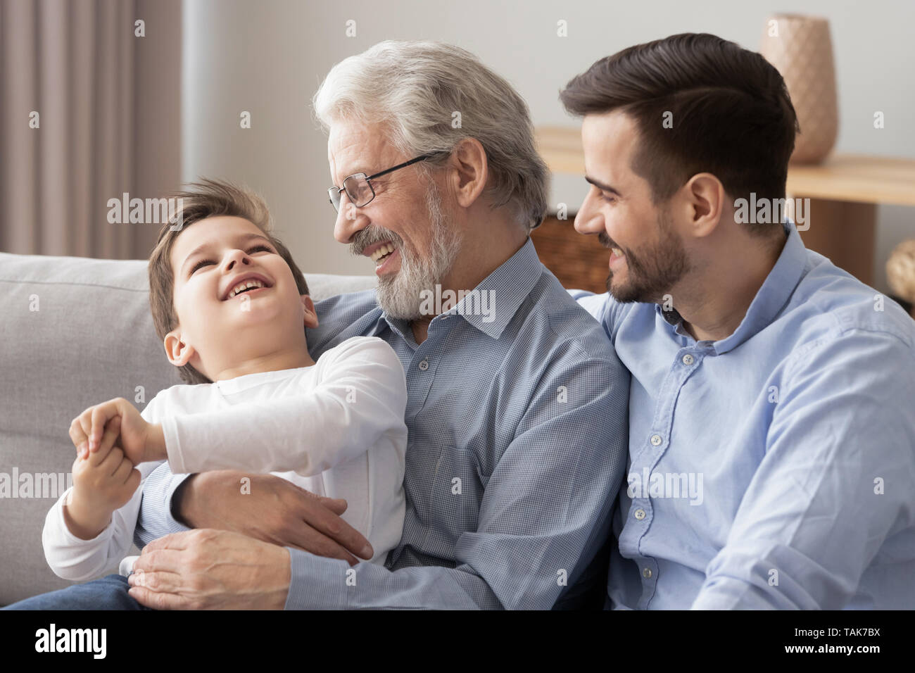 Three generations of men have fun relaxing together Stock Photo - Alamy