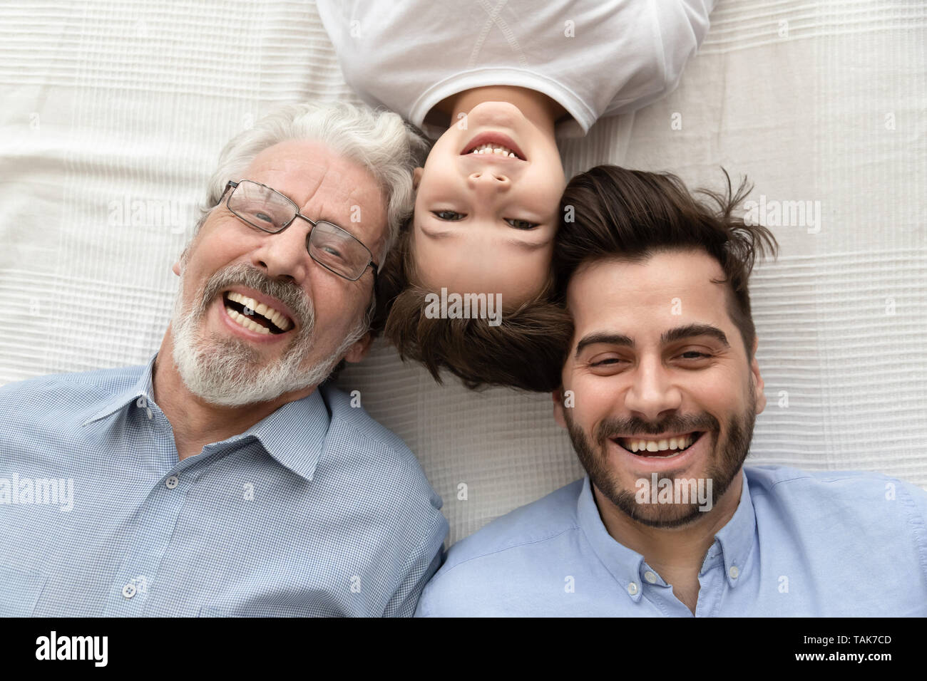 Top view of happy three generations of men smiling Stock Photo - Alamy