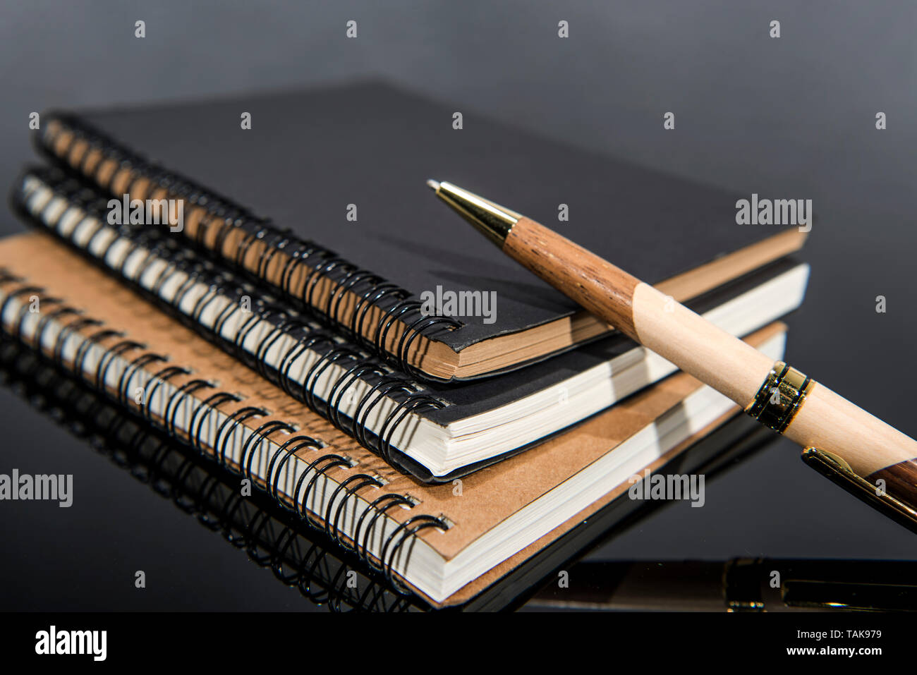 Folders,paper and pen on black glass table Stock Photo - Alamy
