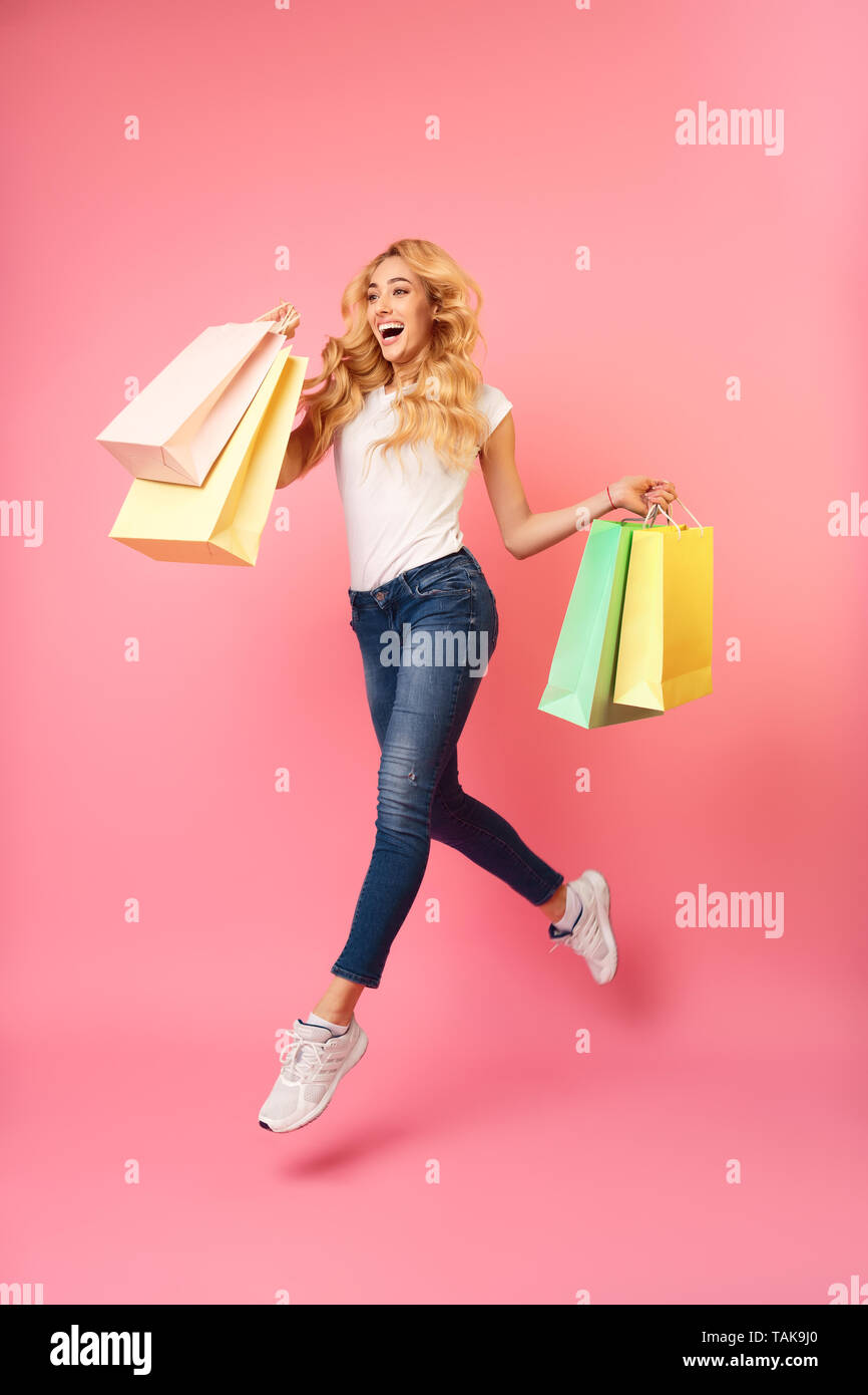 Happy Shopping. Girl Running With Colourful Bags Stock Photo - Alamy