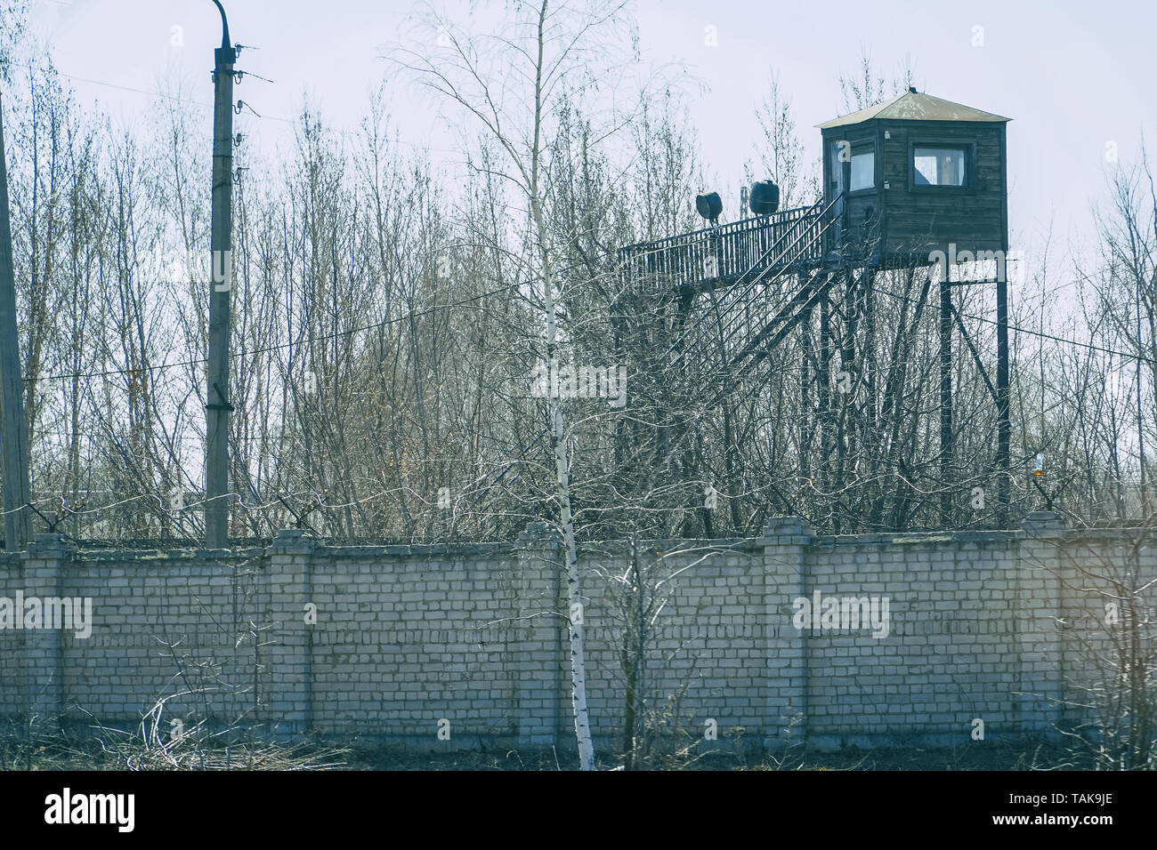 Watchtower at the fence with barbed wire Stock Photo - Alamy