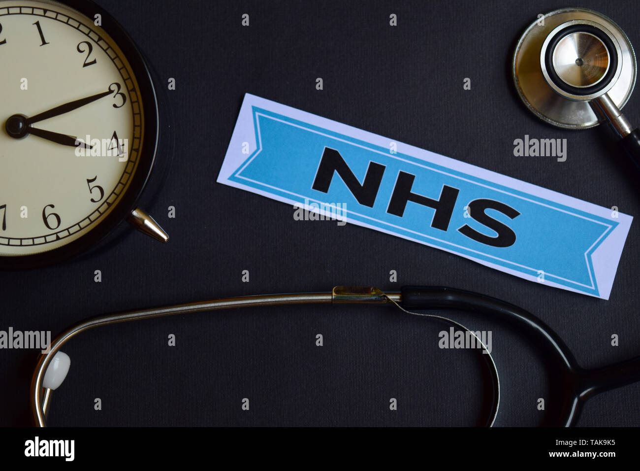 NHS on the print paper with Healthcare Concept Inspiration. alarm clock ...
