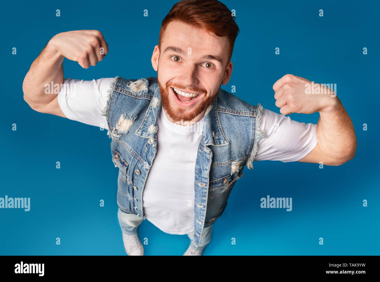 Funny young man showing biceps hi-res stock photography and images - Alamy