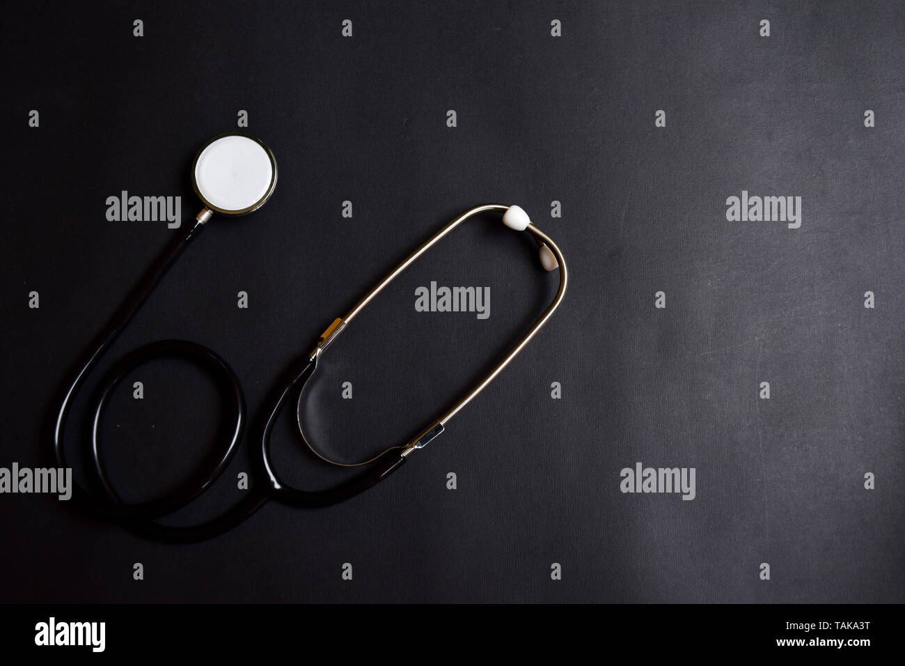 Black stethoscope. Healthcare isolated black background Stock Photo - Alamy