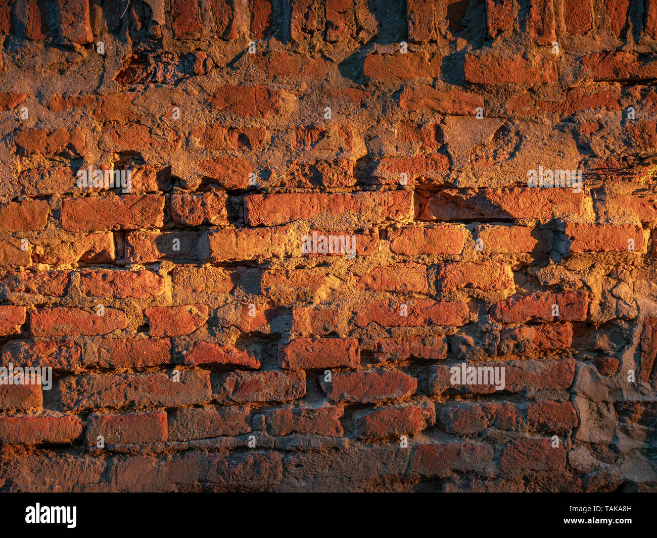Old red grunge brick wall background during sunset Stock Photo - Alamy