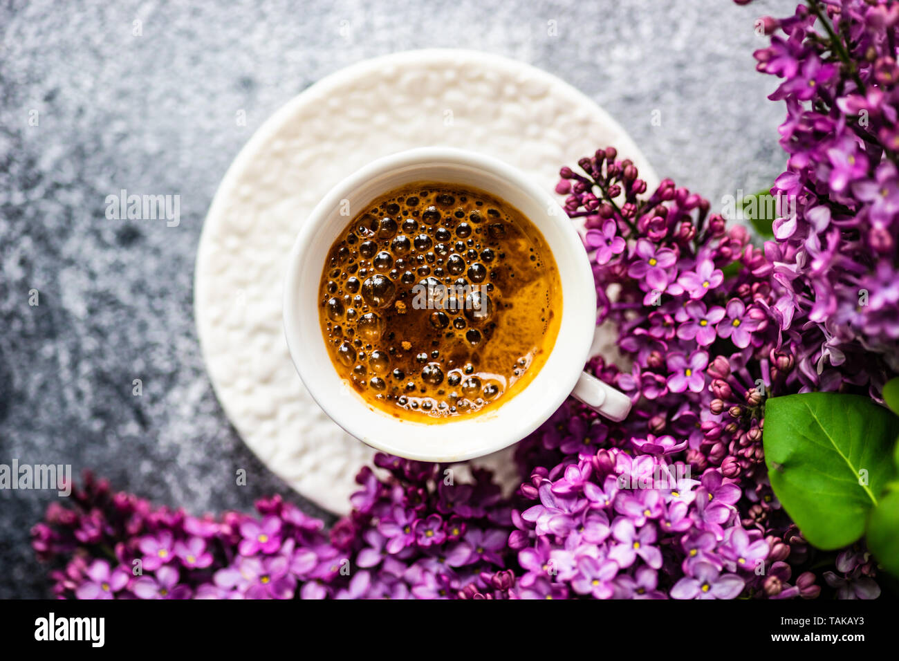 Spring floral frame concept with lilac flowers and cup of coffee on ...
