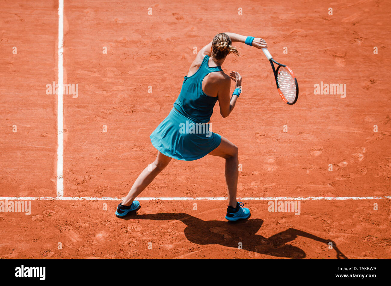Back view of a woman playing forehand in tennis outdoor competition ...