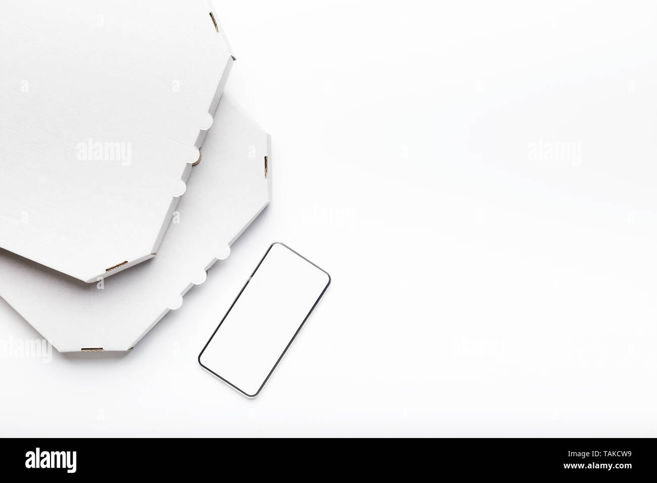 Online Pizza Delivery. Phone Next To Boxes On White Background Stock ...
