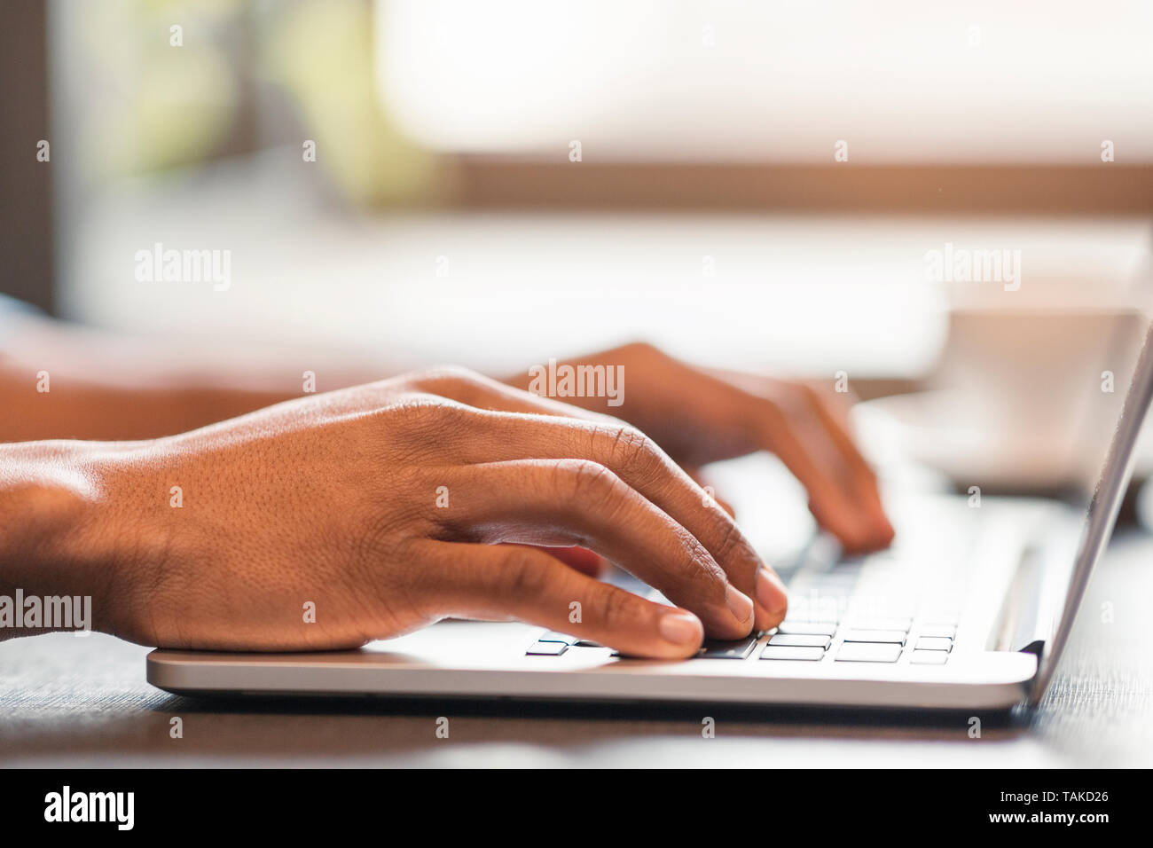 African teenager typing on laptop, browsing information Stock Photo - Alamy