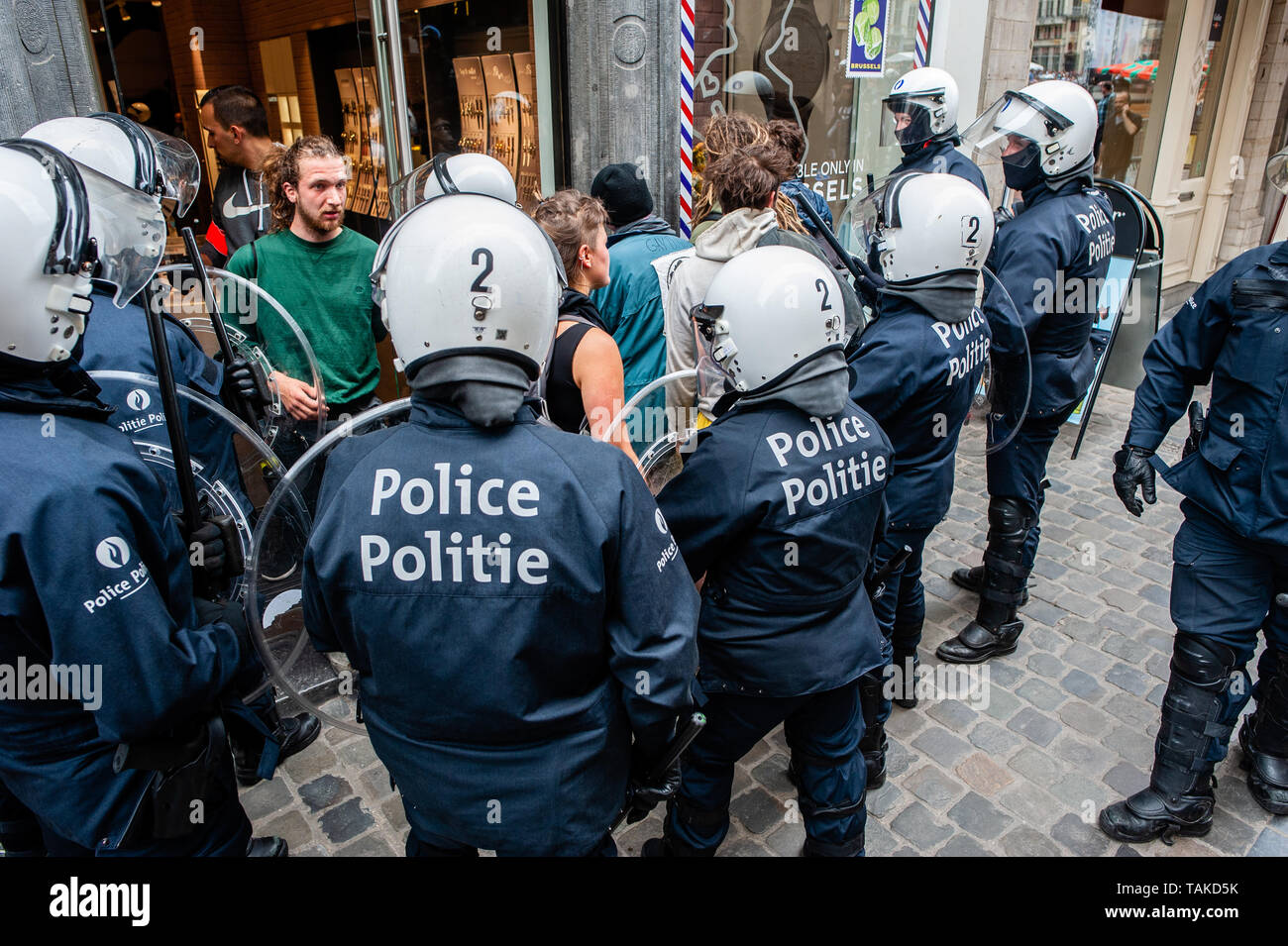 Some yellow vests are seen hiding inside a store while being arrested ...