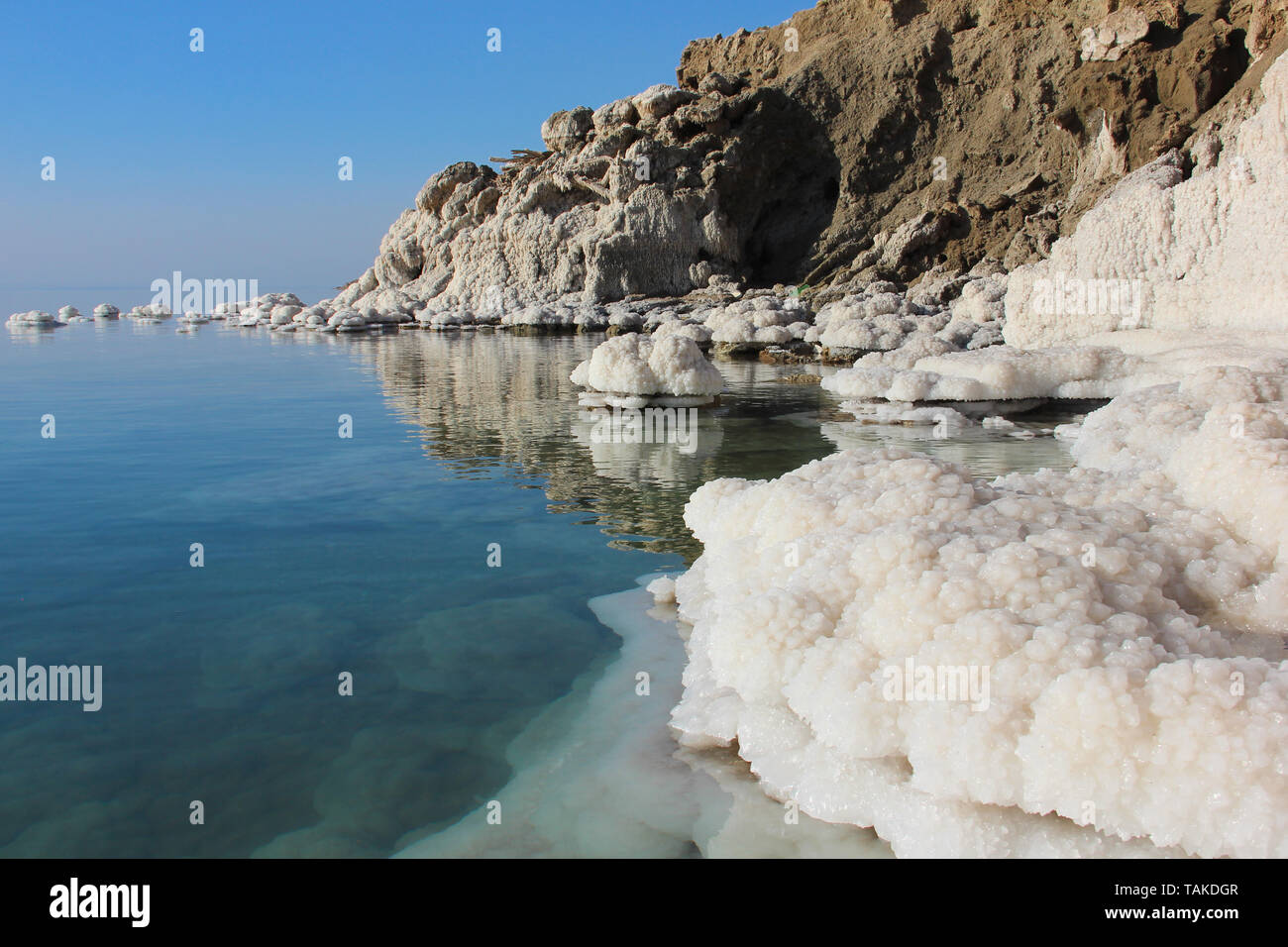 Landscape shot of The Dead Sea shore in Jordan, showing white salt ...