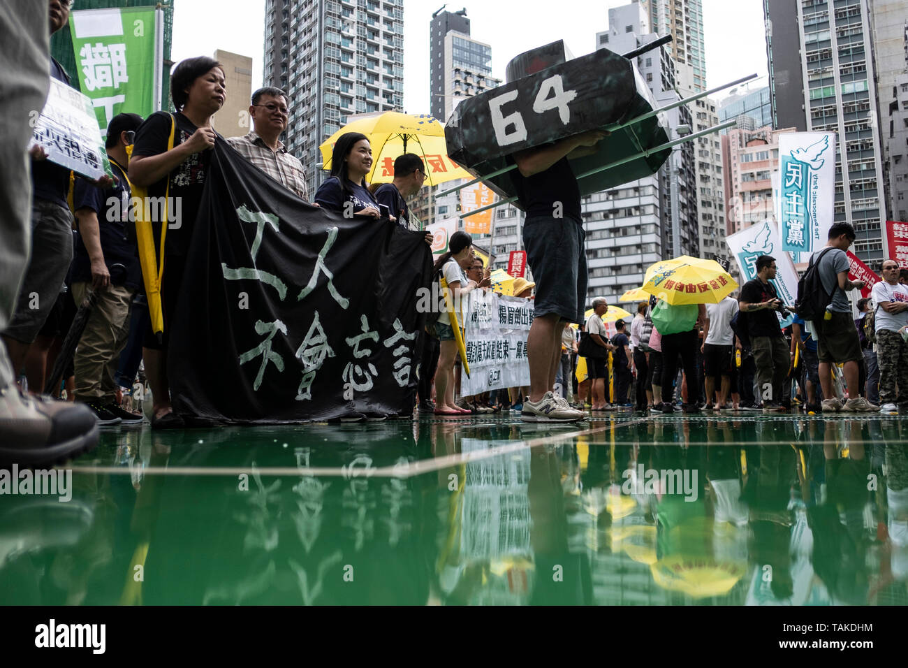 Protester seen carrying a replica of a tank next to those with banners ...