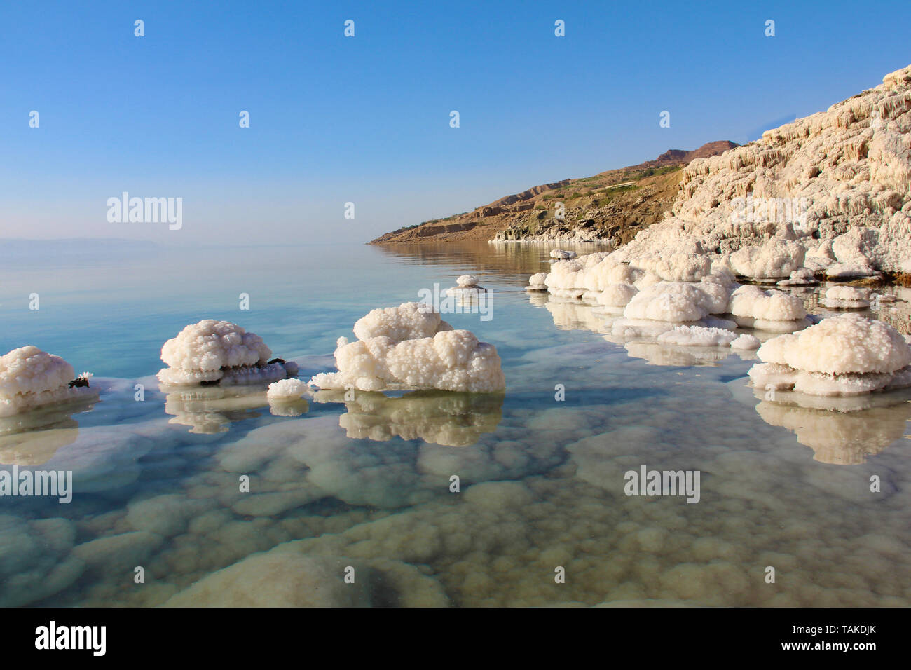 Landscape shot of The Dead Sea shore in Jordan, a clear blue sky, white ...