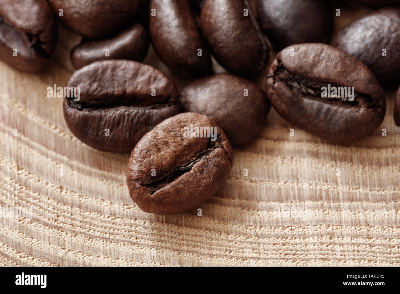 Coffee beans on natural wooden texture background. Coffee background or ...