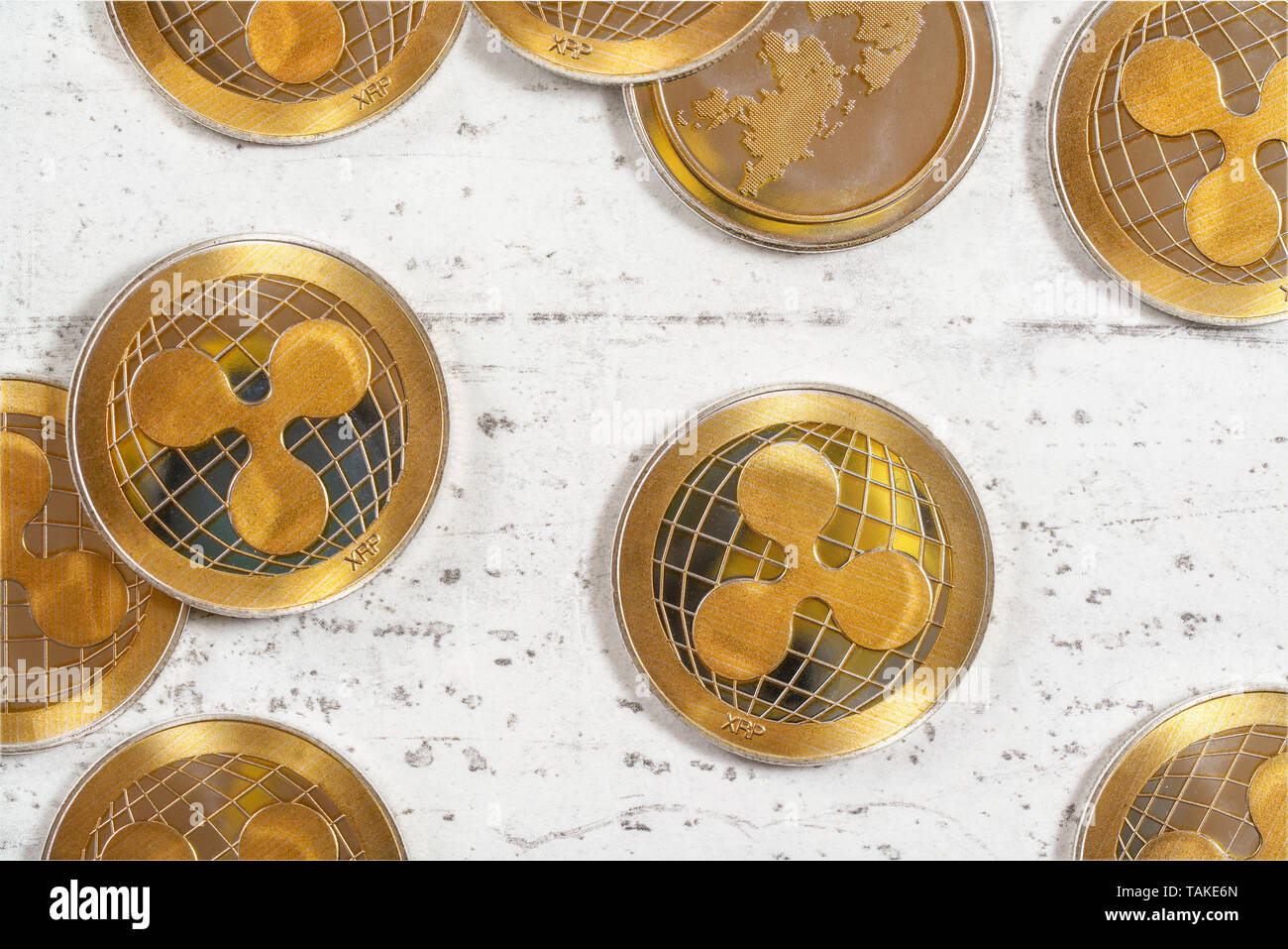 Flat lay photo - golden ripple cryptocurrency coins on white stone ...