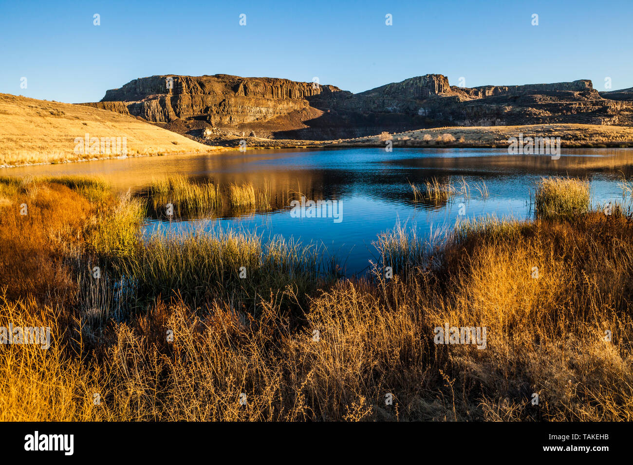 A view of the shoreline and cliffs above Ancient lake in Potholes ...